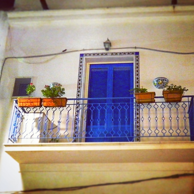White Balcony with Blue Shutters - Experience Sicily